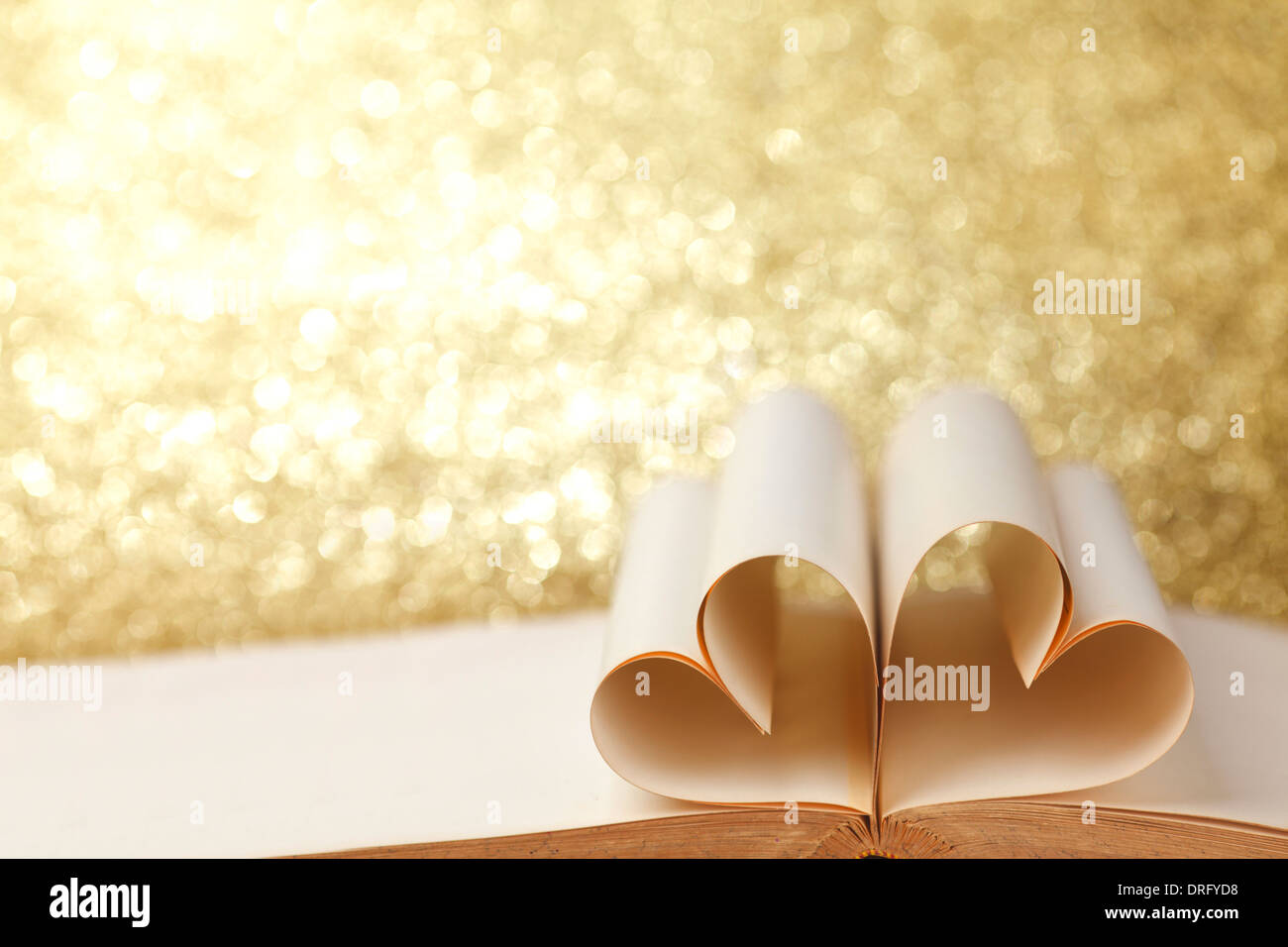 Heart made of blank pages inside a book on glitter background Stock ...