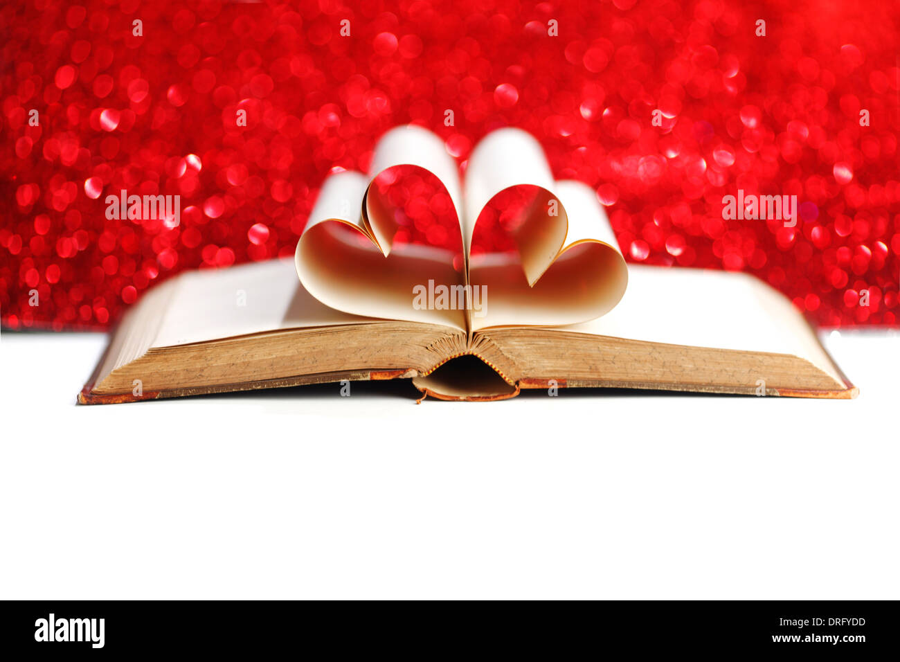Heart made of blank pages inside a book on glitter background Stock ...
