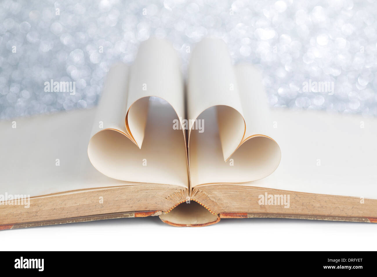 Heart made of blank pages inside a book on glitter background Stock ...