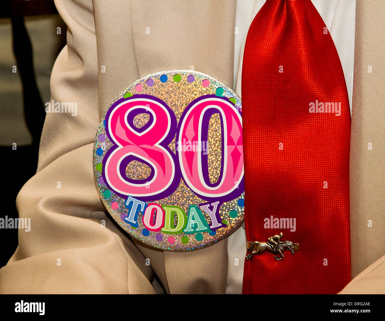 Gentleman wearing an eightieth birthday badge Stock Photo - Alamy