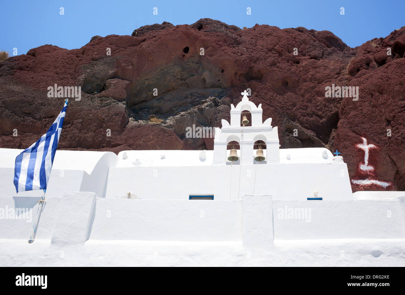 Traditional church with Greece flag in red beach, Santorini Stock Photo ...