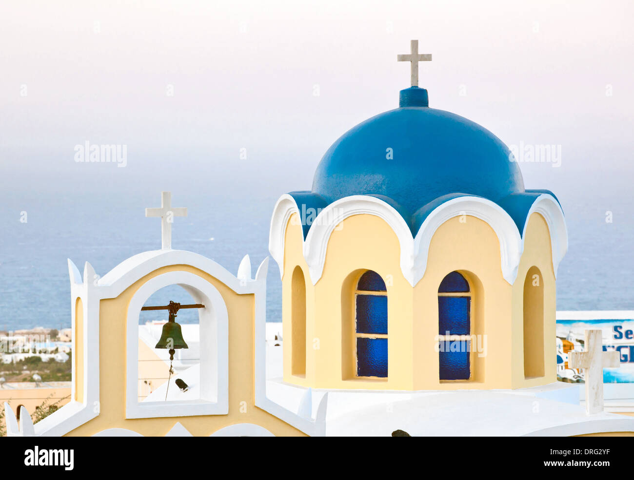 Traditional blue cupola with yellow church in Thira, Santorini, Greece ...