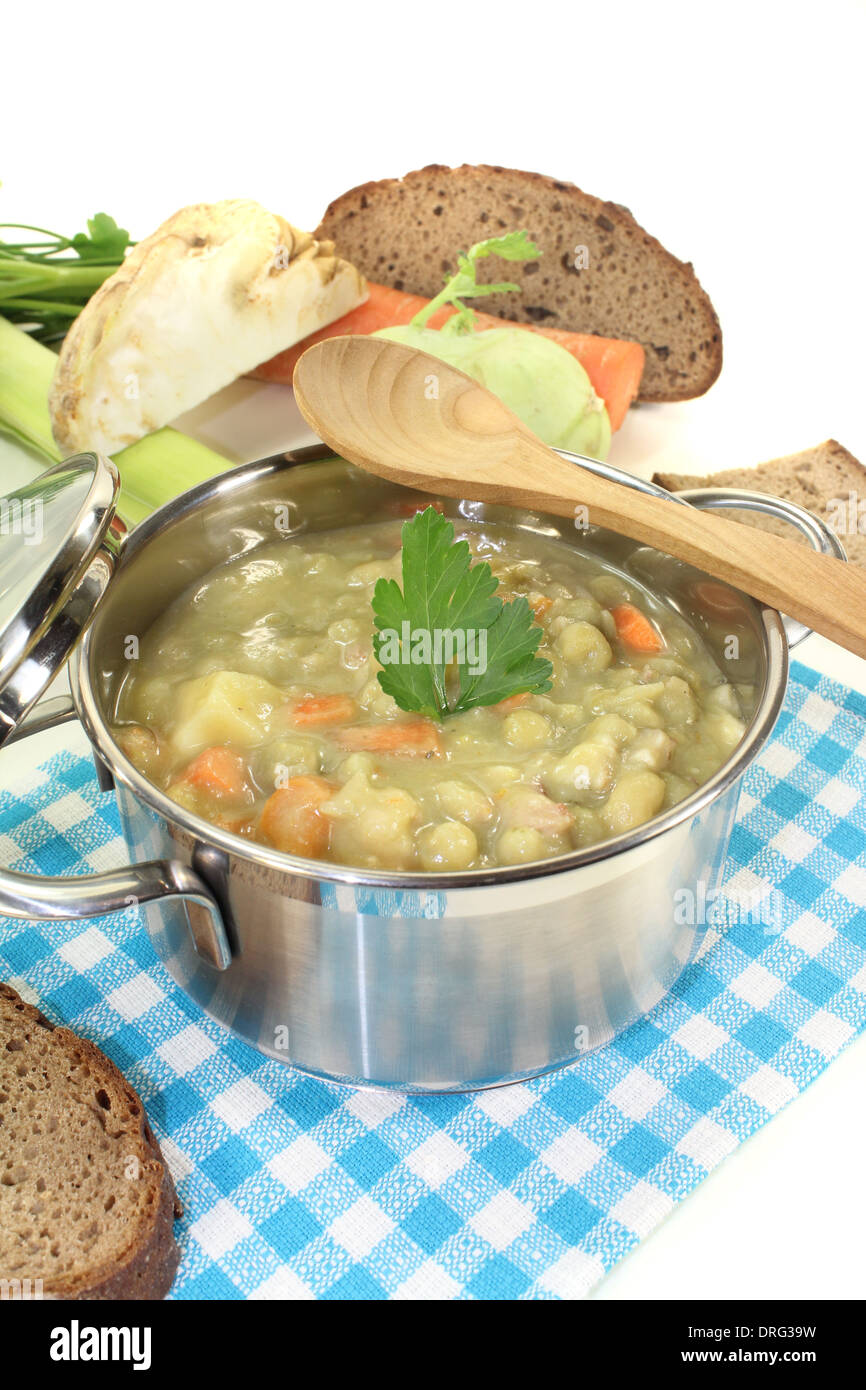 fresh pea stew with carrots on a light background Stock Photo - Alamy