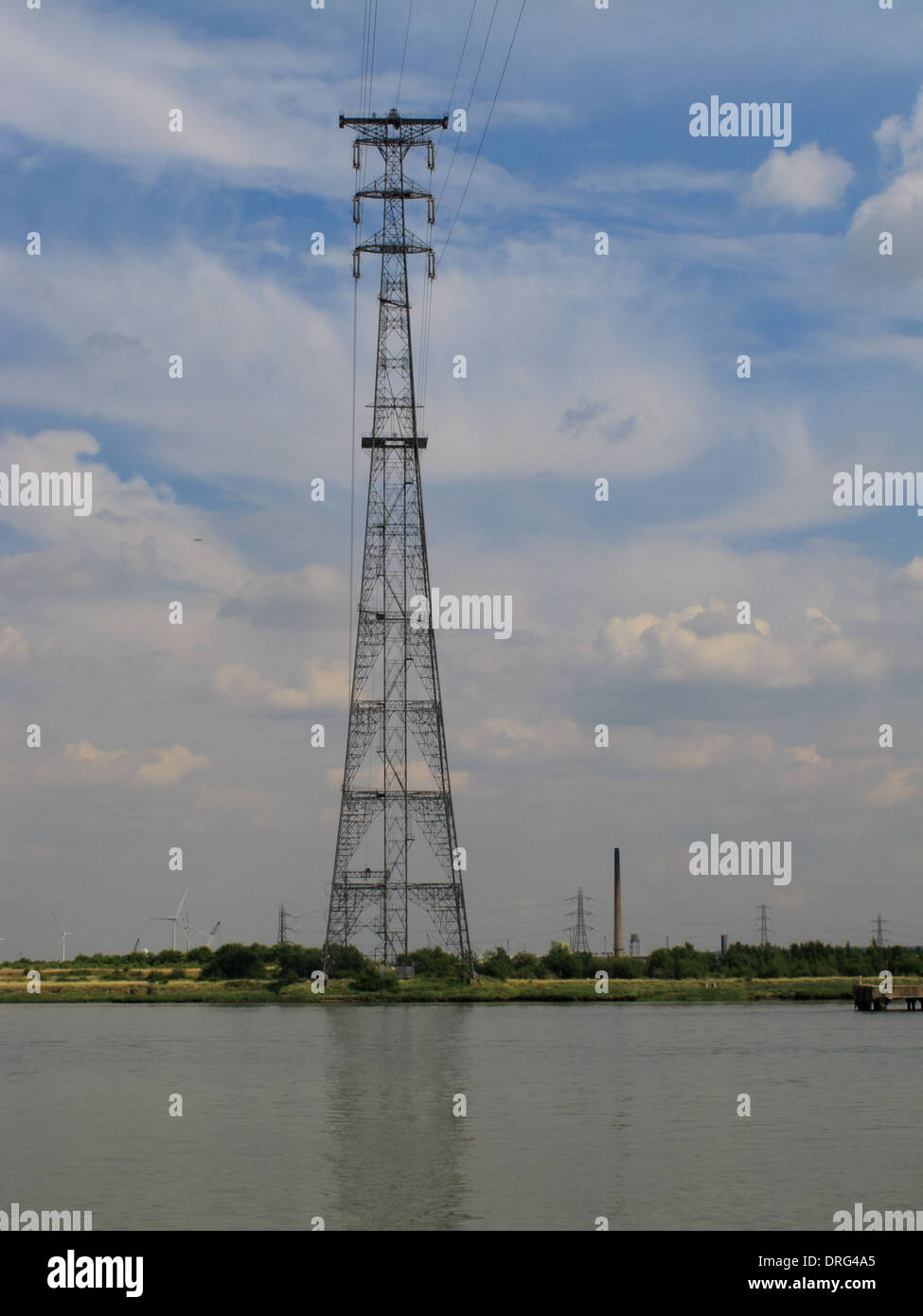 An image of a tall electric pylon overlooking the river Stock Photo - Alamy