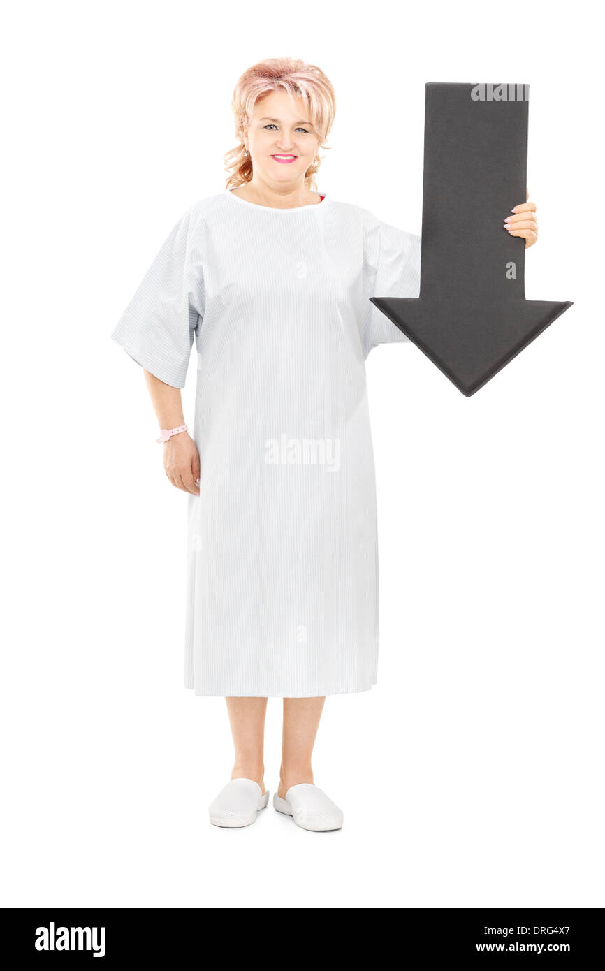 Full length portrait of female patient in hospital gown holding big ...