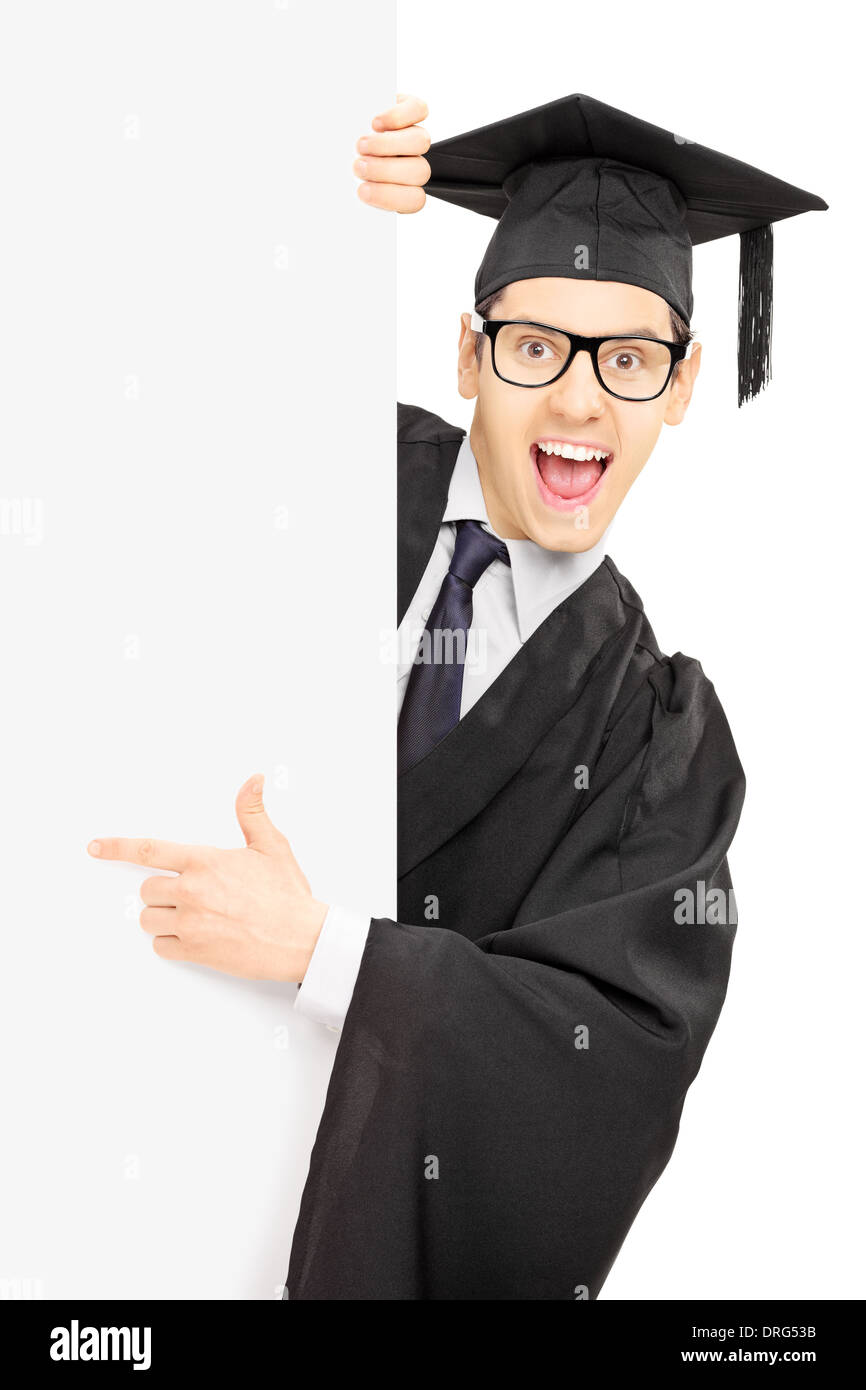 Male graduate student peeking from behind a blank panel and pointing ...