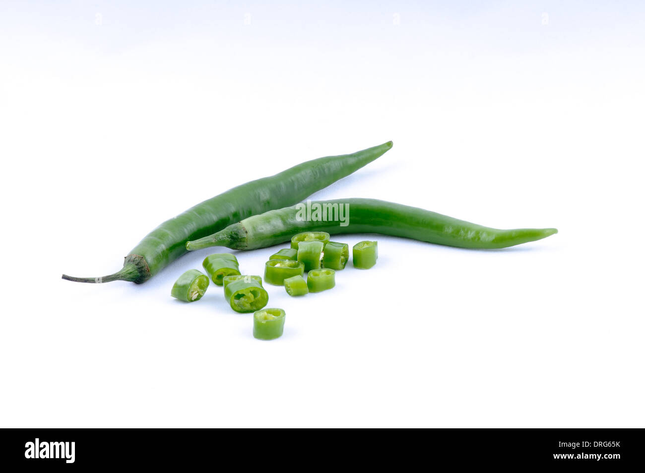 whole and chopped chillies on white background. horizontal studio shot ...