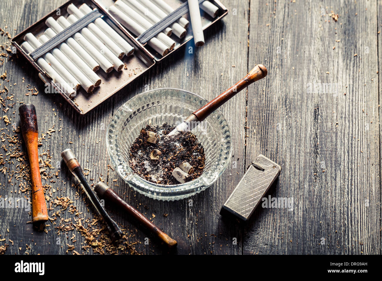 Thin pipe with burning cigarette Stock Photo - Alamy