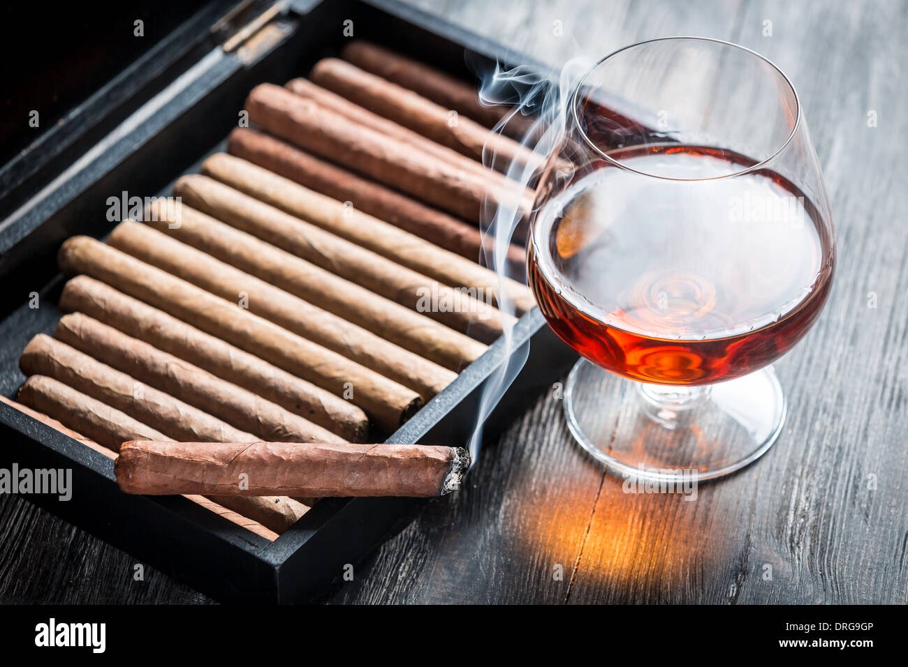 Rising aroma of burnt cigar and cognac Stock Photo - Alamy
