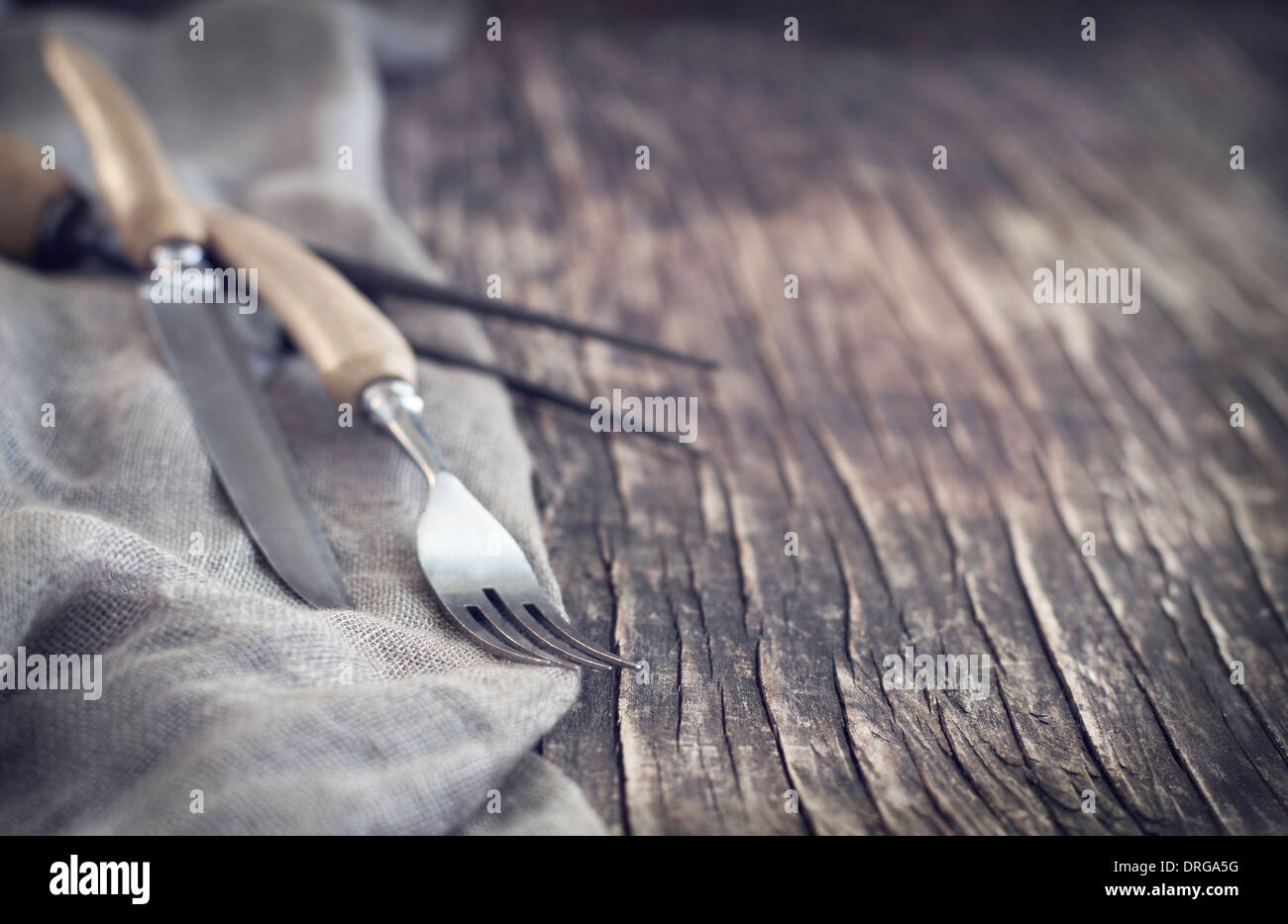 Vintage silverware on rustic background, small depth of field. Toned ...