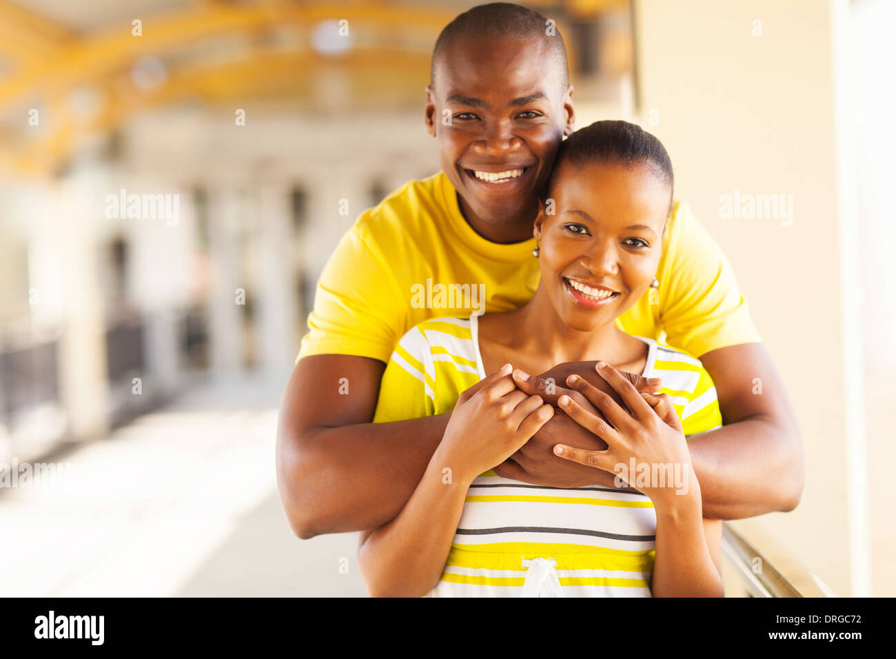 portrait of young African American couple hugging Stock Photo - Alamy