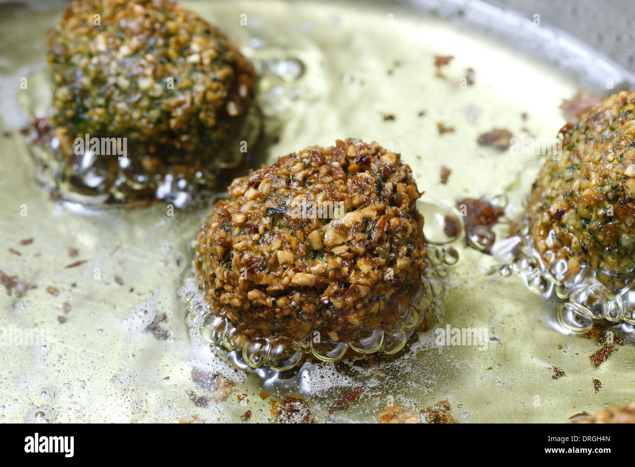 Homemade falafel balls frying in cooking oil Stock Photo - Alamy