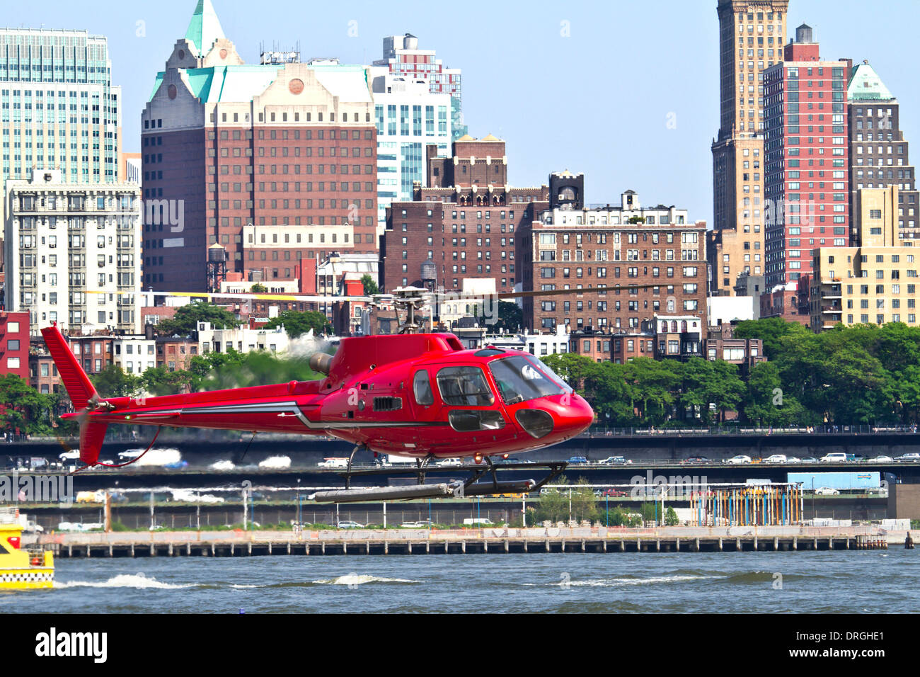 Helicopter landing on a heliport with Manhattans skyline as background ...