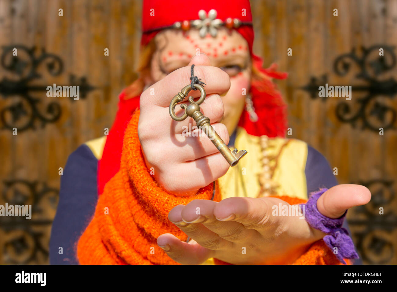 Colorful dressed gypsy girl holds magic prophetess key Stock Photo - Alamy