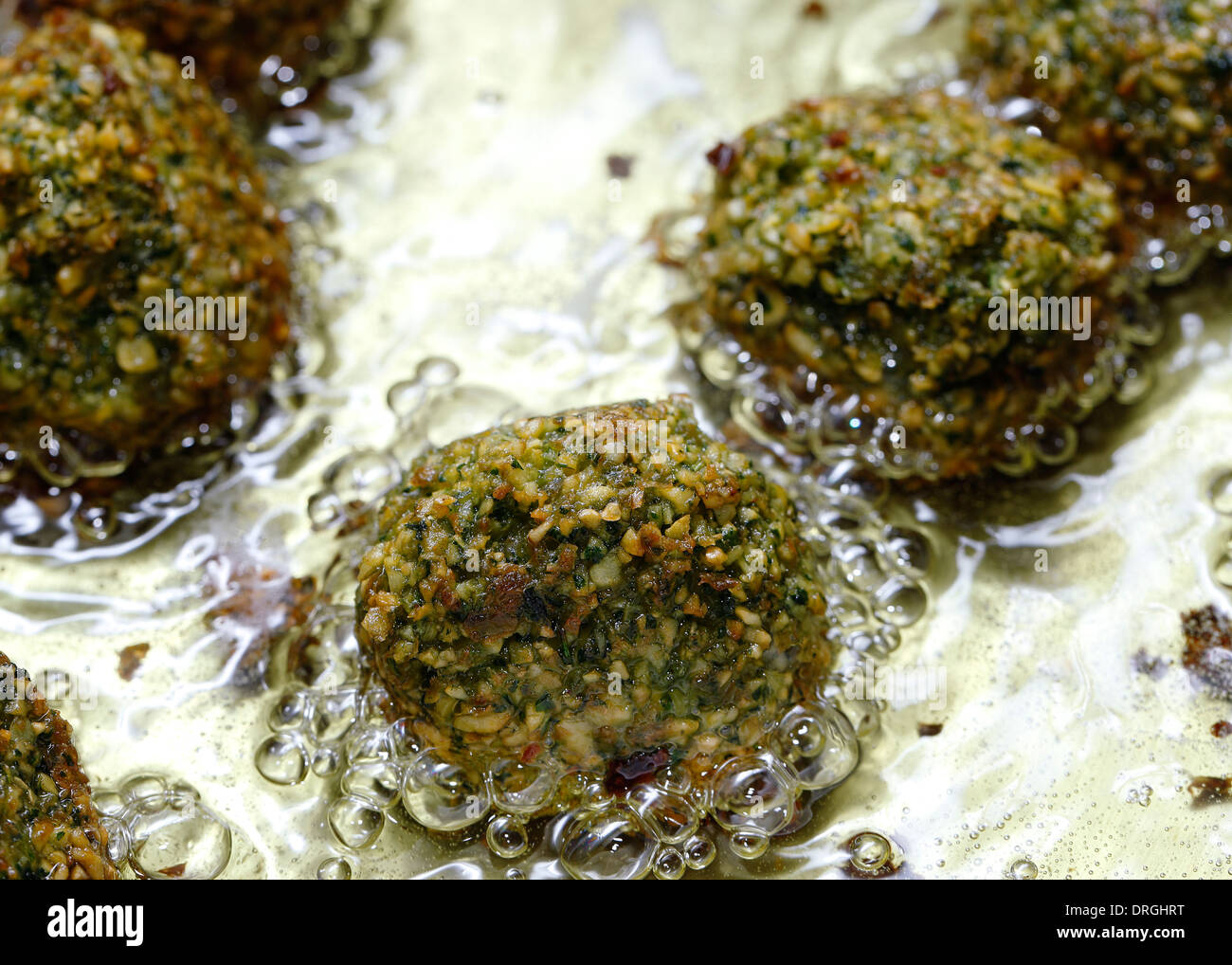 Homemade falafel mixture frying in oil Stock Photo - Alamy