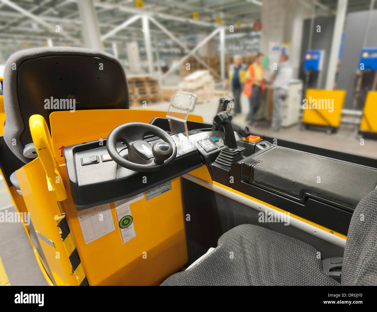 Parked forklift in an industry warehouse, workers and shelves in the ...