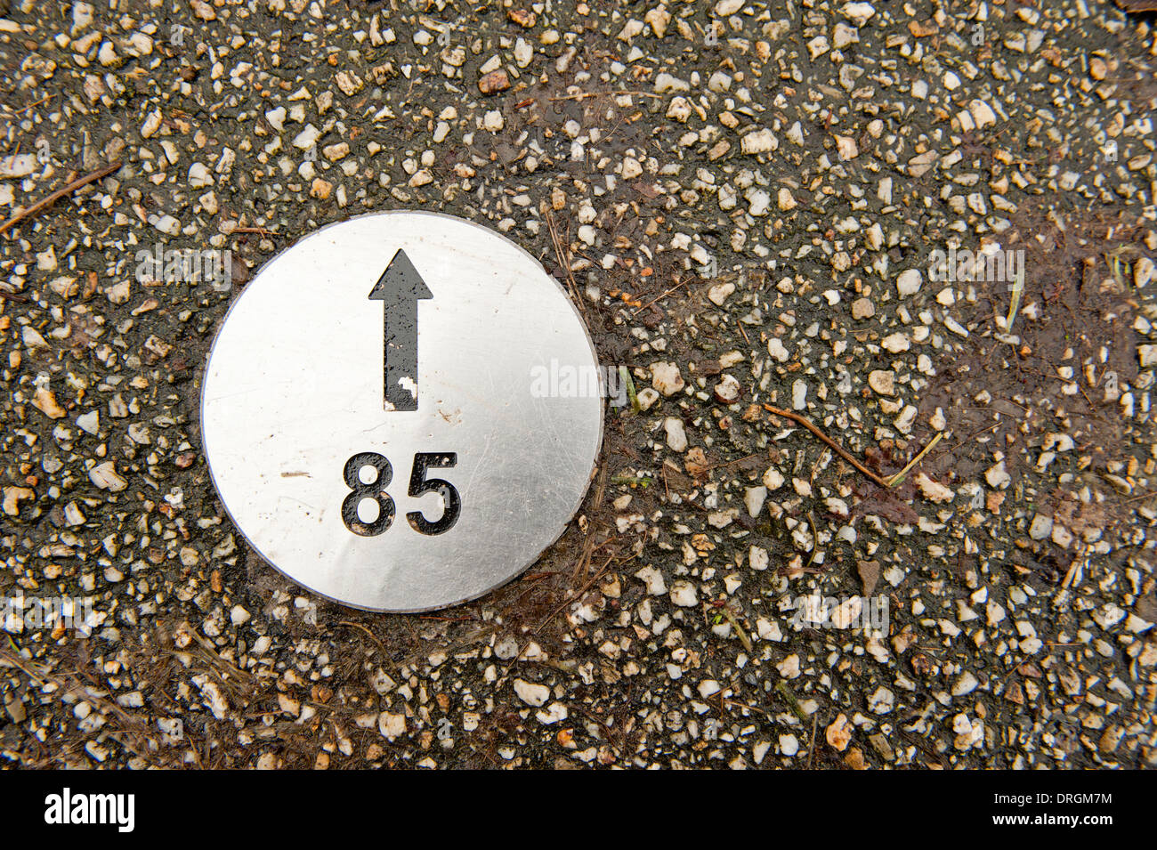 Numbered direction sign with arrow cemented in pavement Stock Photo - Alamy
