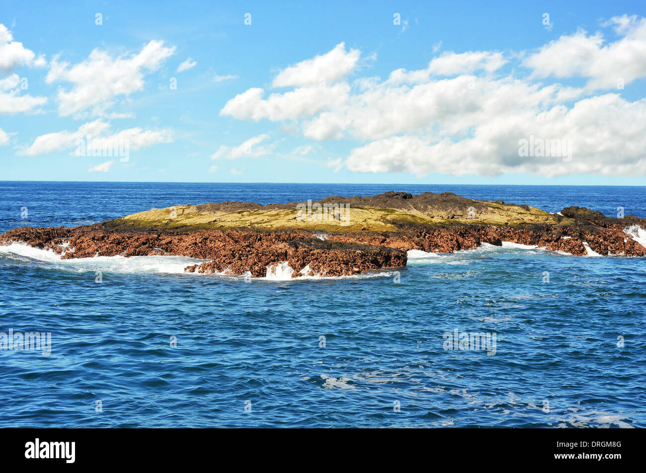 Flat lava rock formation just out of the Pacific ocean Stock Photo - Alamy