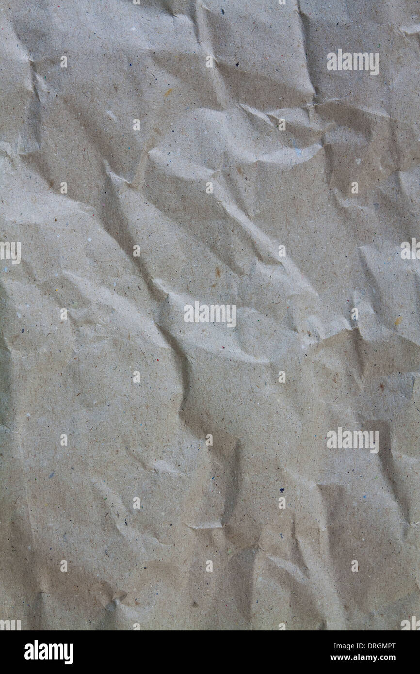 Wrinkled wrapping paper with bright and dark areas in the background ...