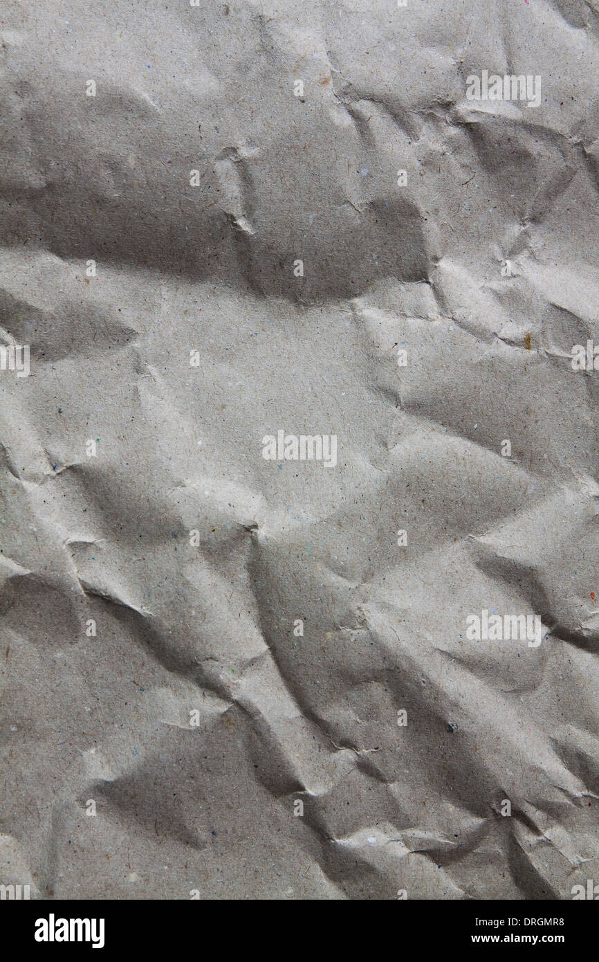 Wrinkled wrapping paper with bright and dark areas in the background ...