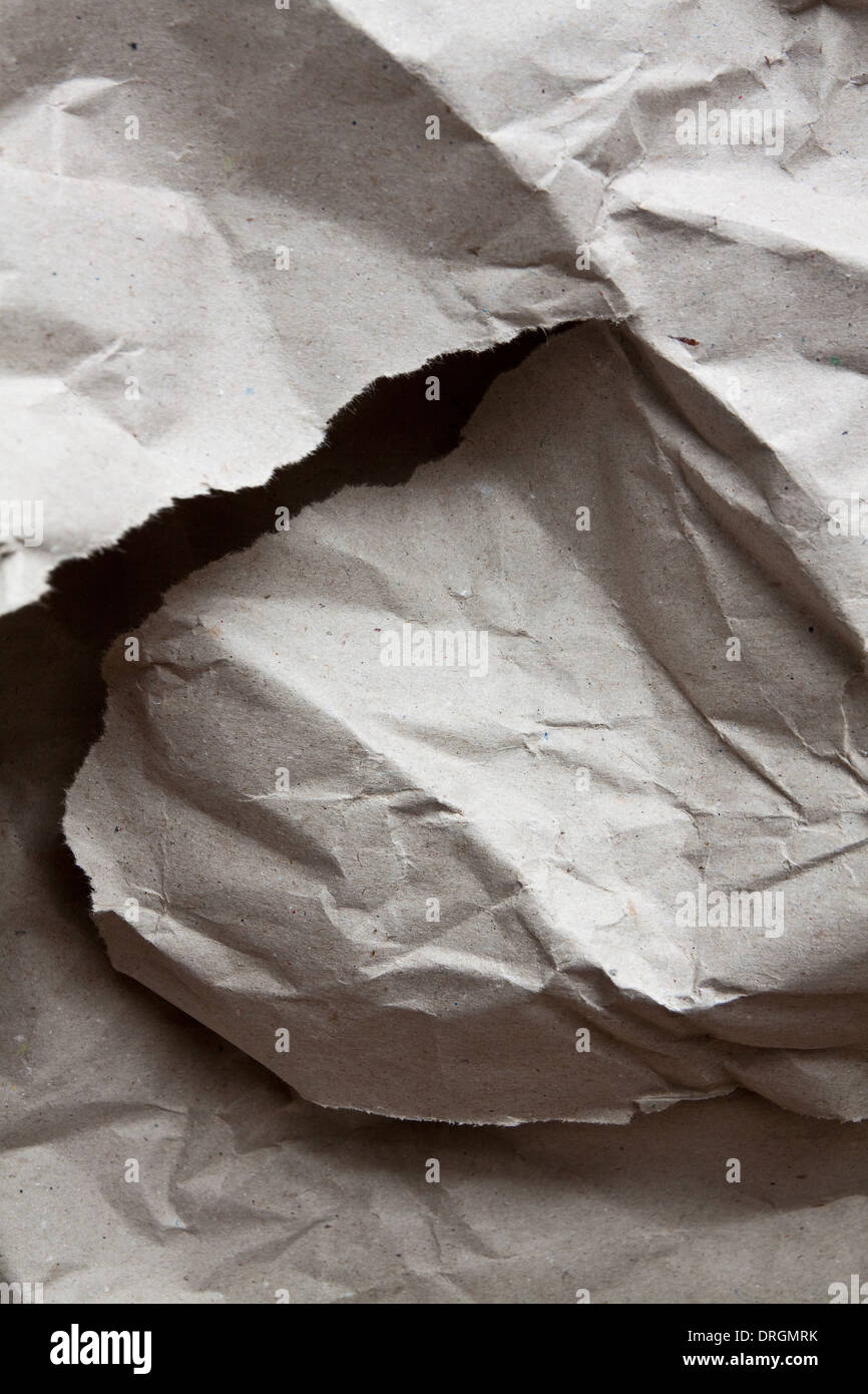 Wrinkled wrapping paper with bright and dark areas in the background ...