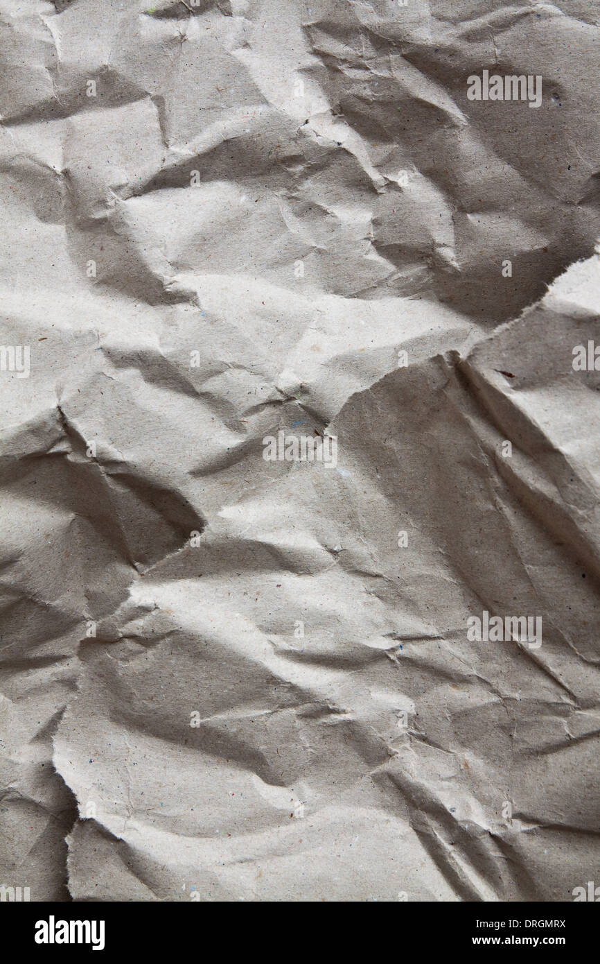 Wrinkled wrapping paper with bright and dark areas in the background ...