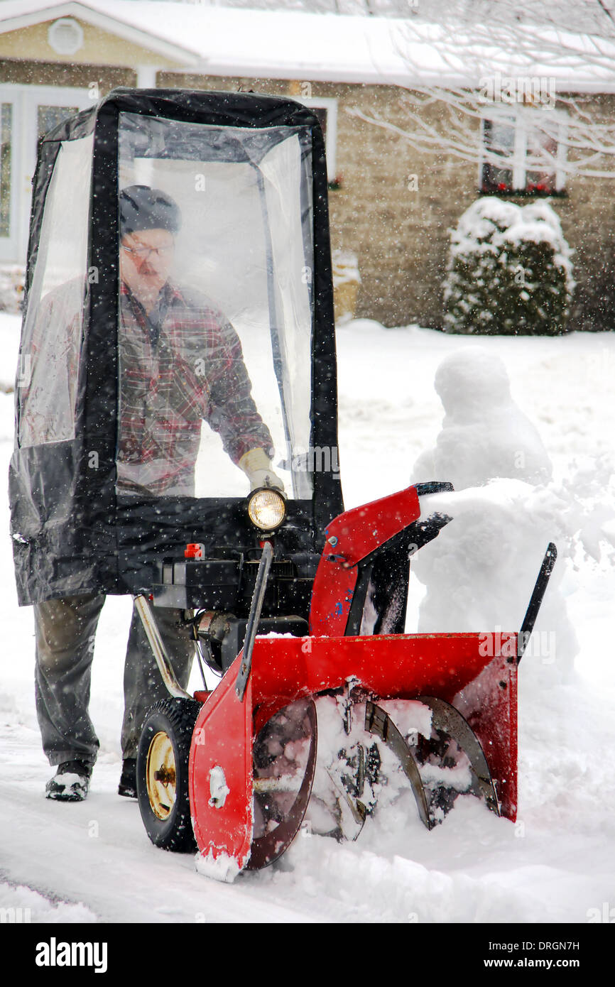 Man pushing snow blower in deep snow hi-res stock photography and ...