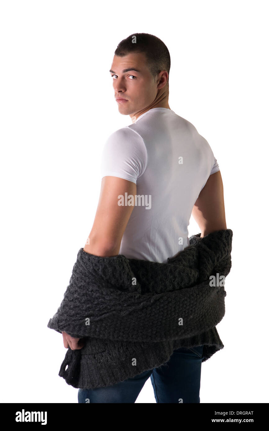 Attractive young man taking off wool sweater, isolated on white ...