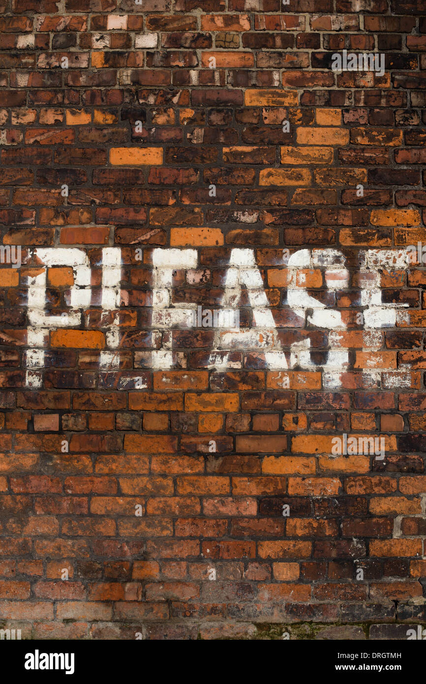 'Please' written on a brick wall with white paint Stock Photo - Alamy