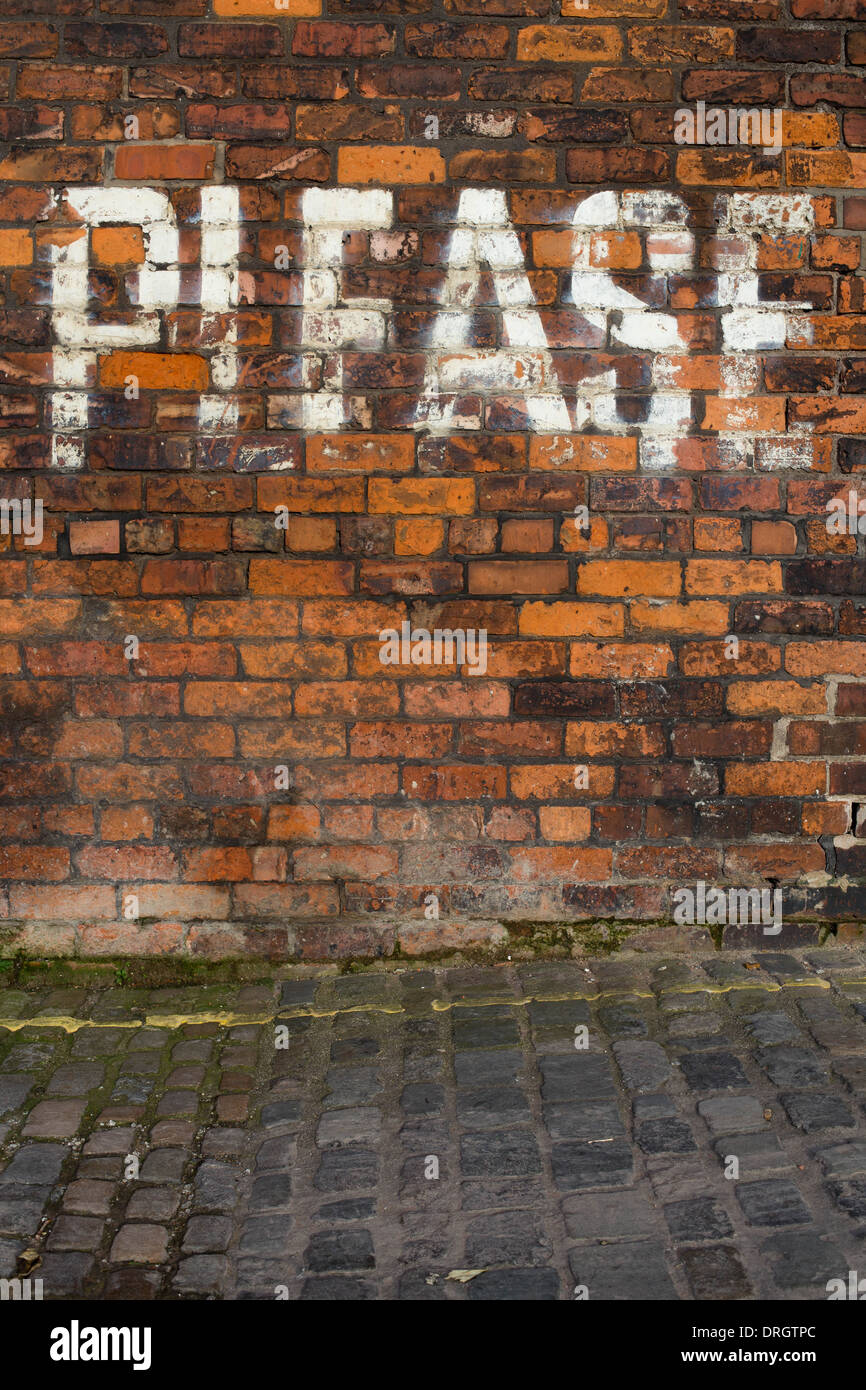 'Please' written on a brick wall with white paint Stock Photo - Alamy