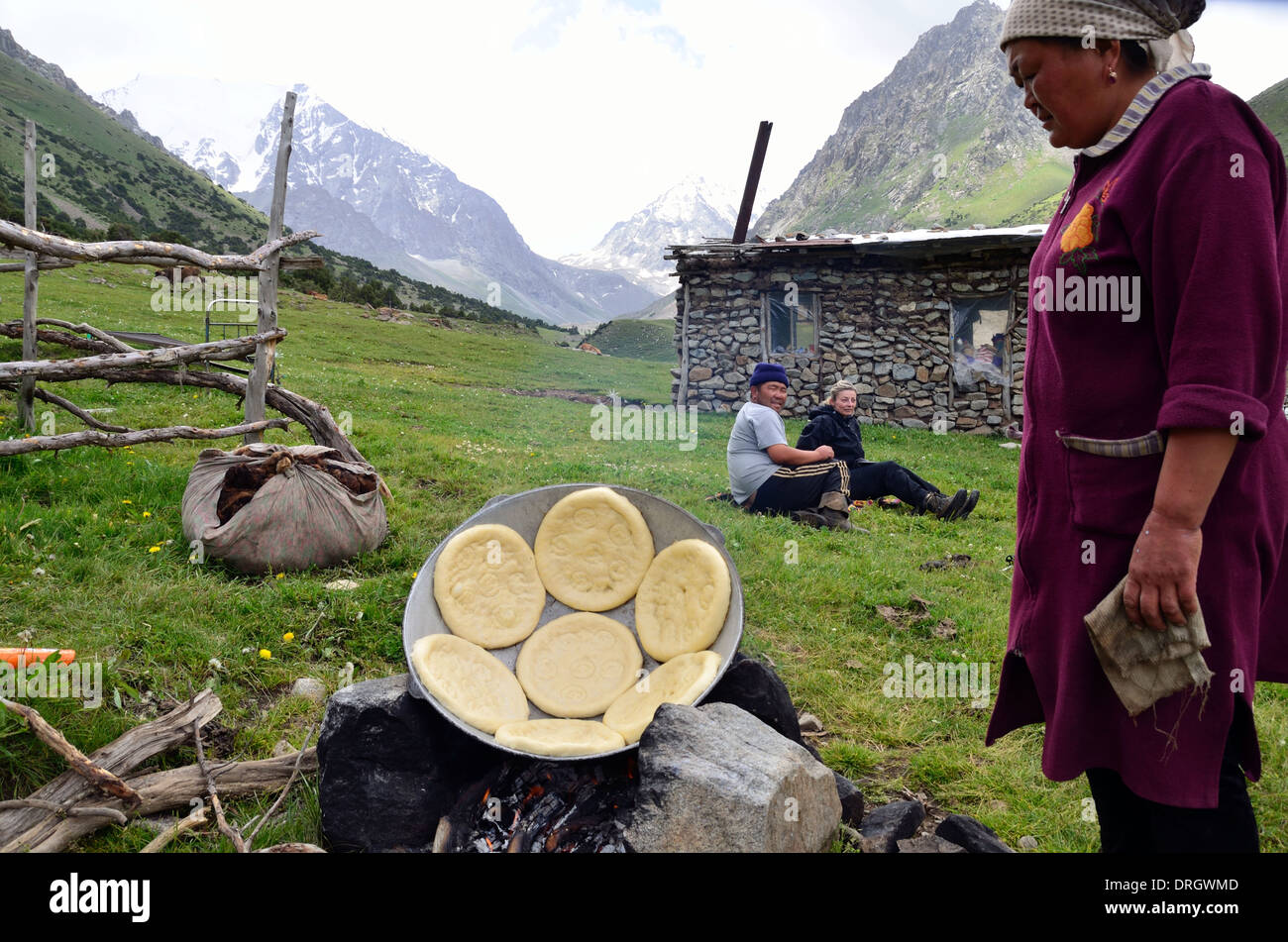 Kyrgyz woman making Kyrgyz bread - lepyoshka - in the mountains of ...