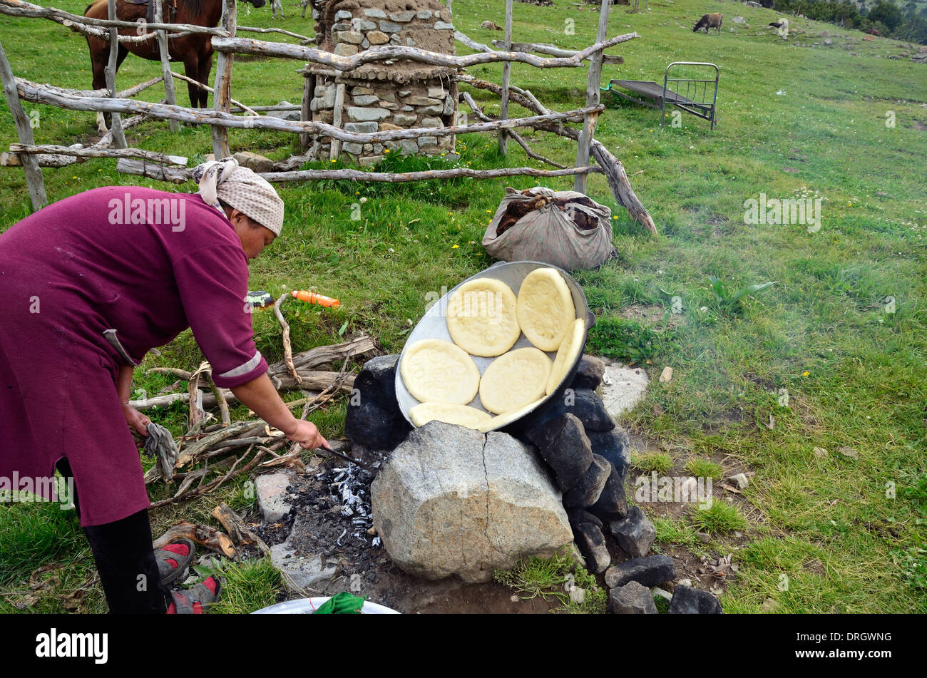 Kyrgyz woman making Kyrgyz bread - lepyoshka - in the mountains of ...