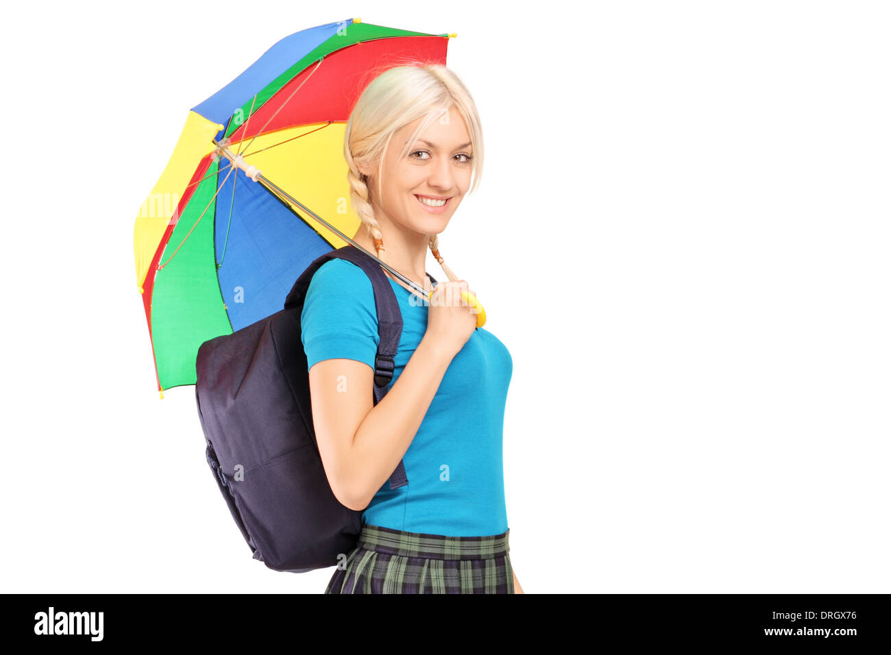 Blond female student walking with umbrella and looking at camera Stock ...