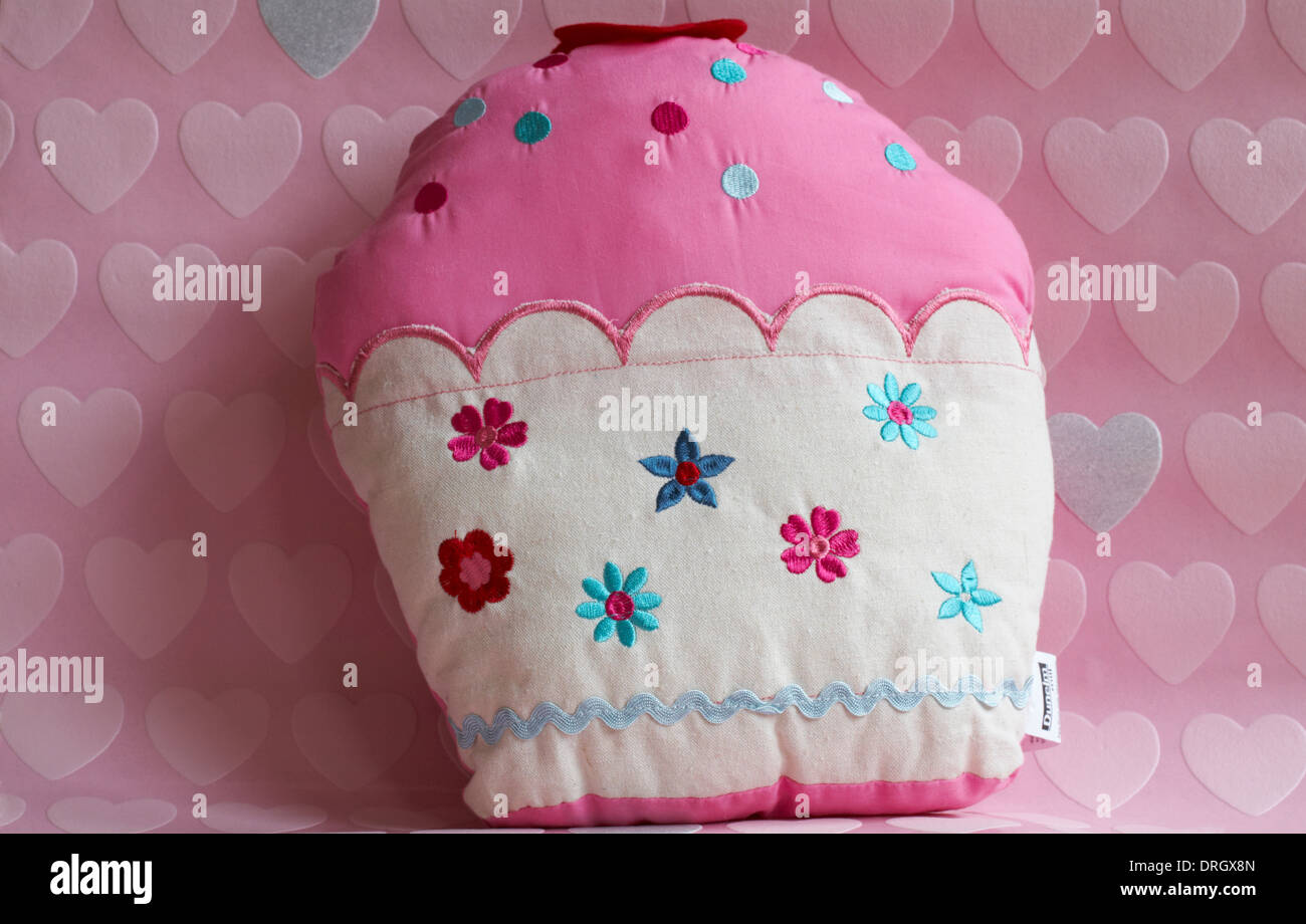 cupcake cushion with pink hearts background Stock Photo - Alamy