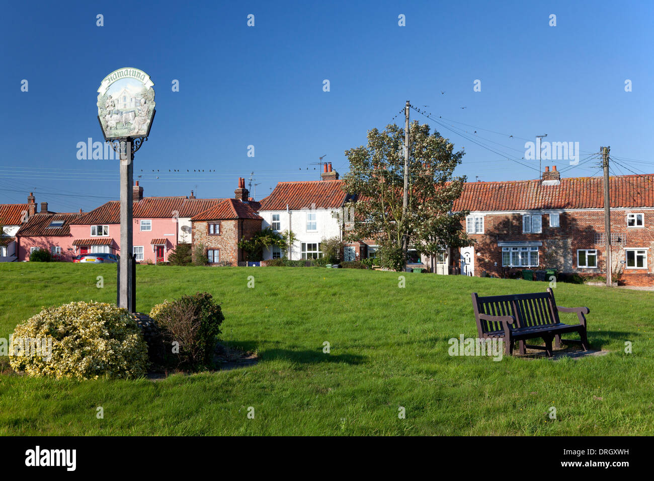 Village sign on the green, with row of cottages alongside, Hempton ...