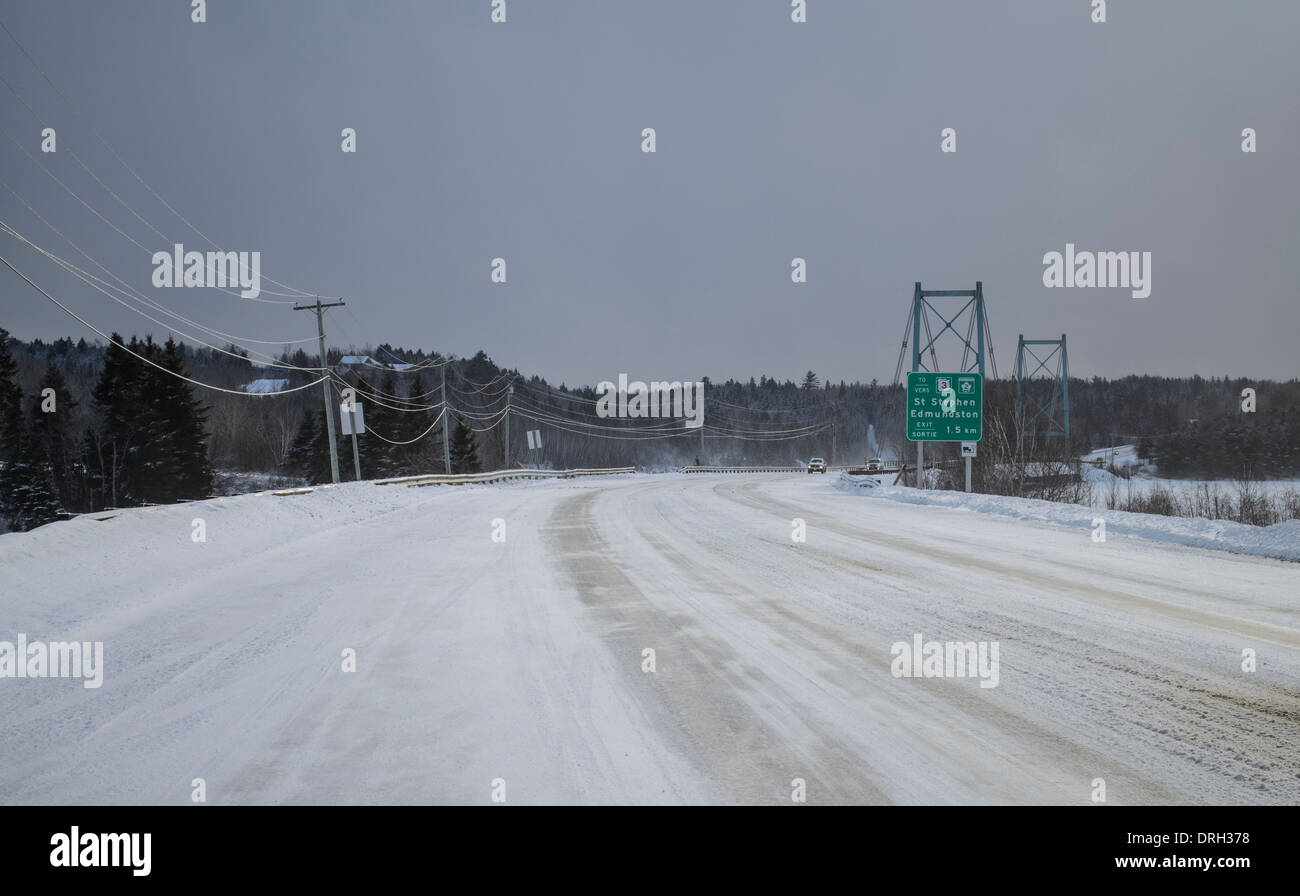 Winter road with signage before suspension bridge Stock Photo - Alamy