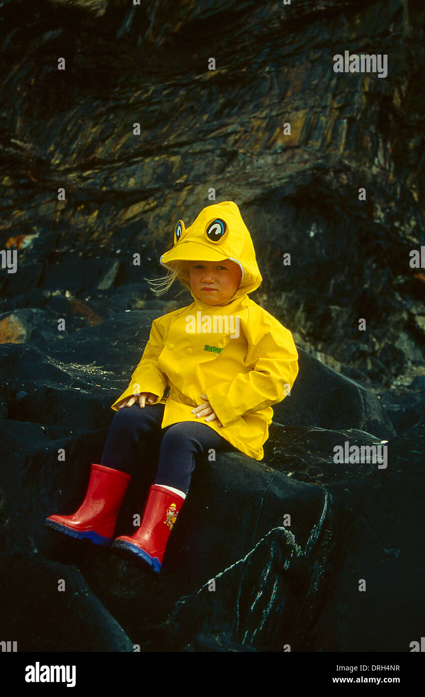child sitting on rocks in a typical British summer Stock Photo - Alamy