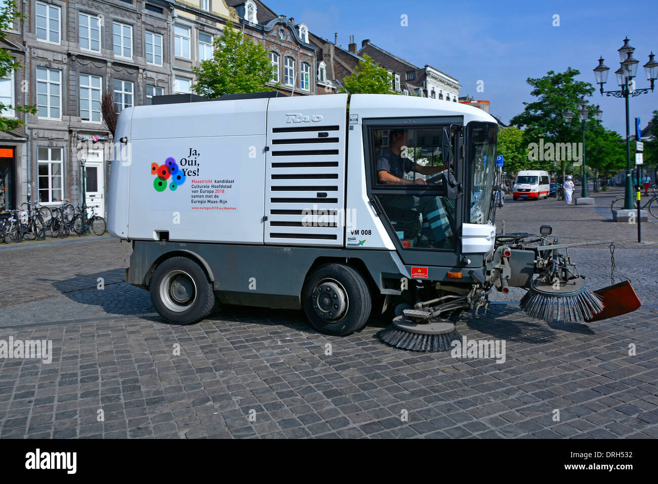 Maastricht City street cleansing machine driver operator in cab driving ...