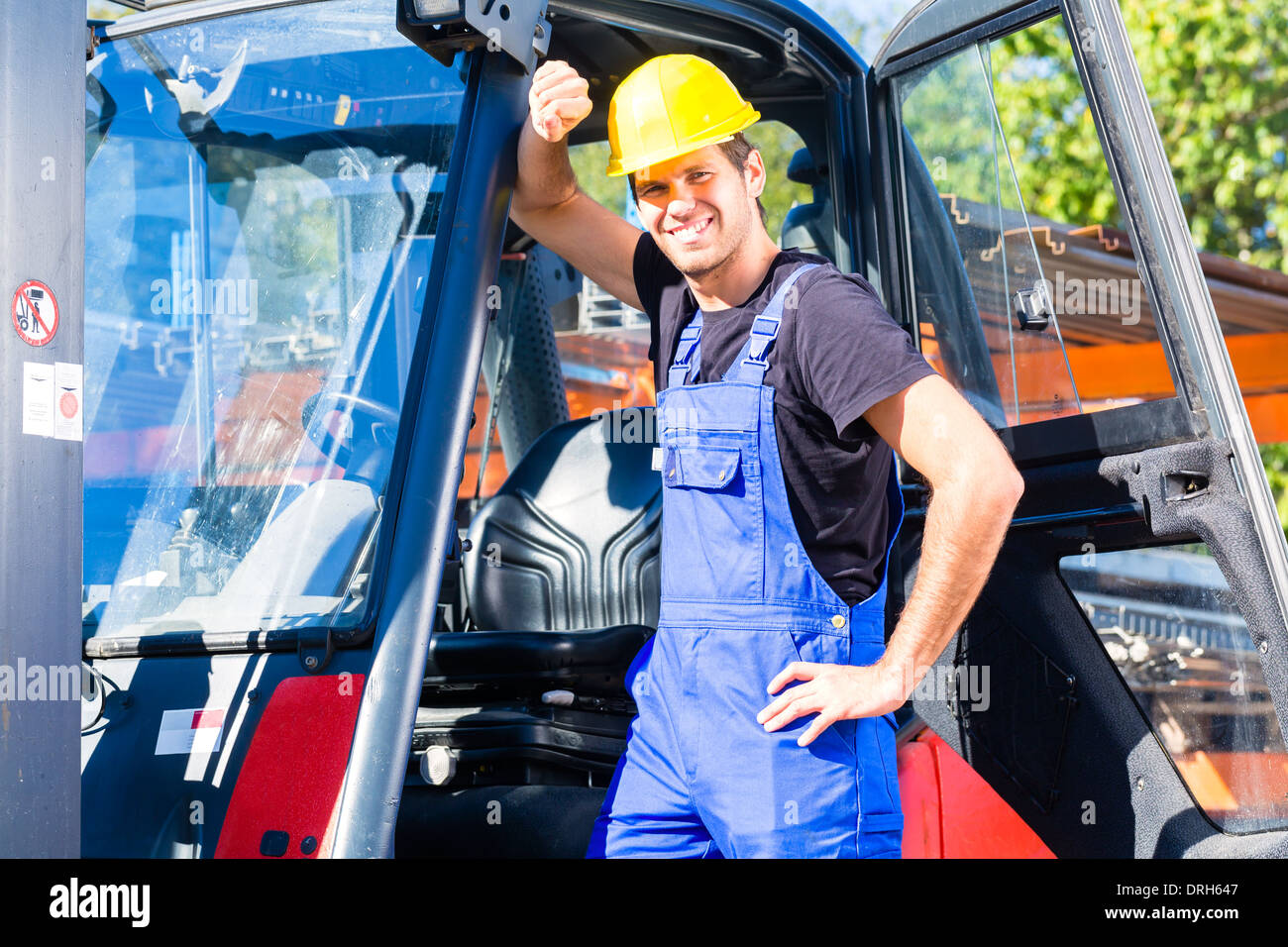 builder or driver with pallet transporter or lift fork truck on ...