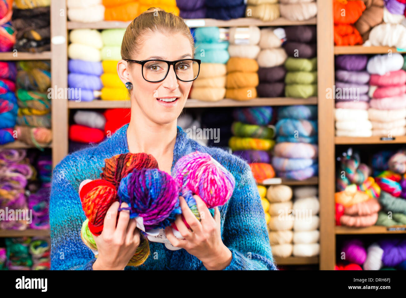 Young woman buying colorful wool and yarn for their hobby in a knitting ...