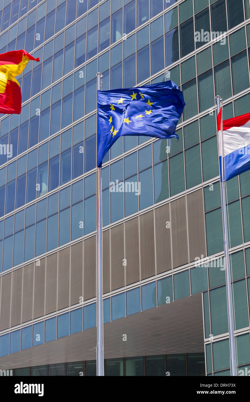 European flag with modern building on the background Stock Photo - Alamy