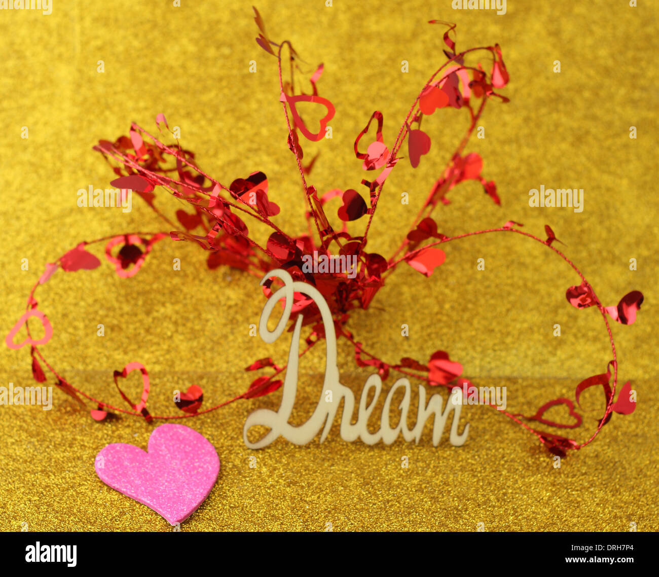 Dream text on a yellow background with red hearts and pink heart Stock ...