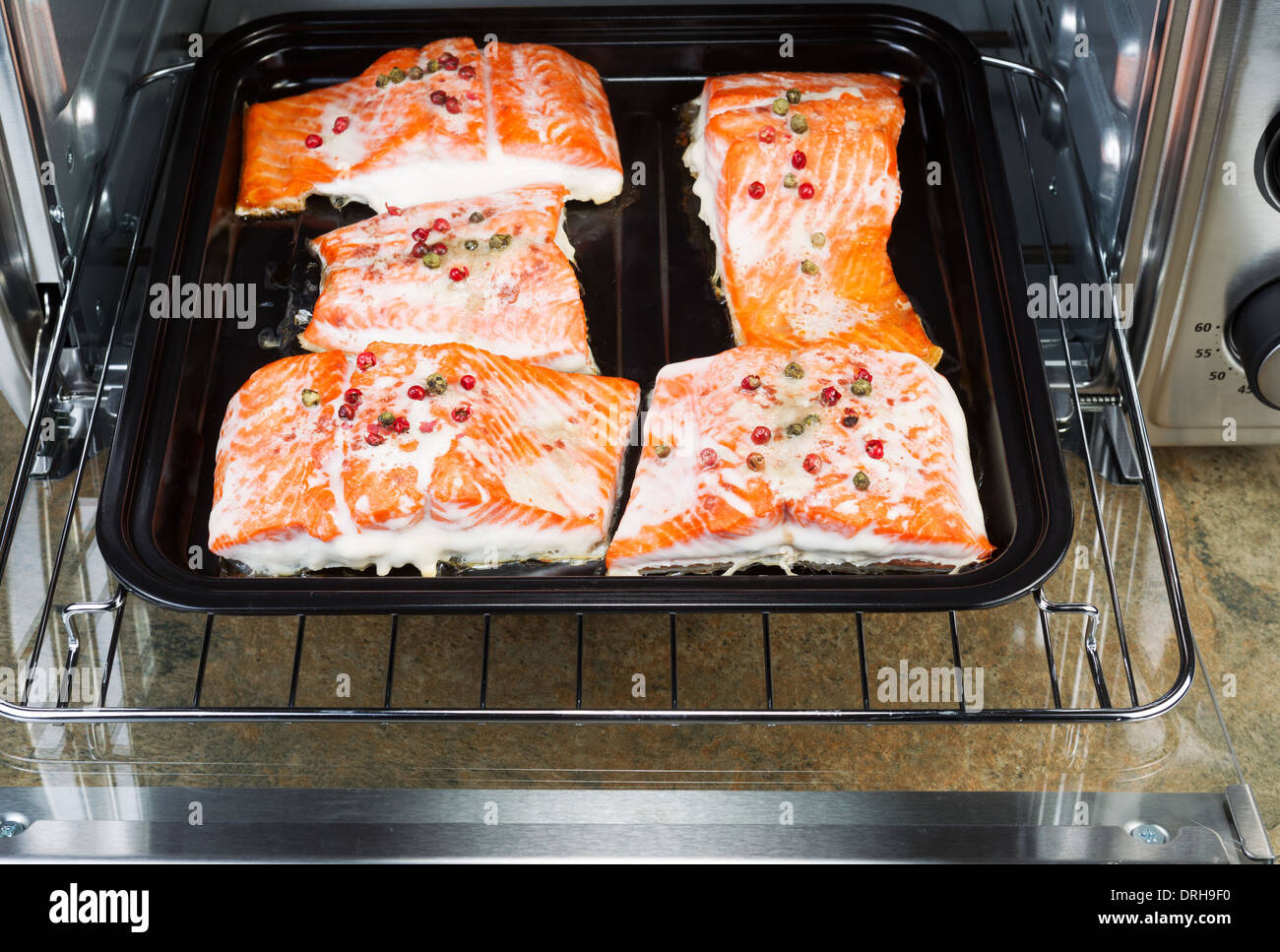Horizontal photo of Baked Wild Red Salmon pieces coated with dried red ...