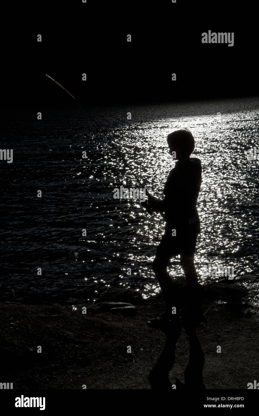 Boy fishing in Lake Dunstan, Central Otago, South Island, New Zealand ...