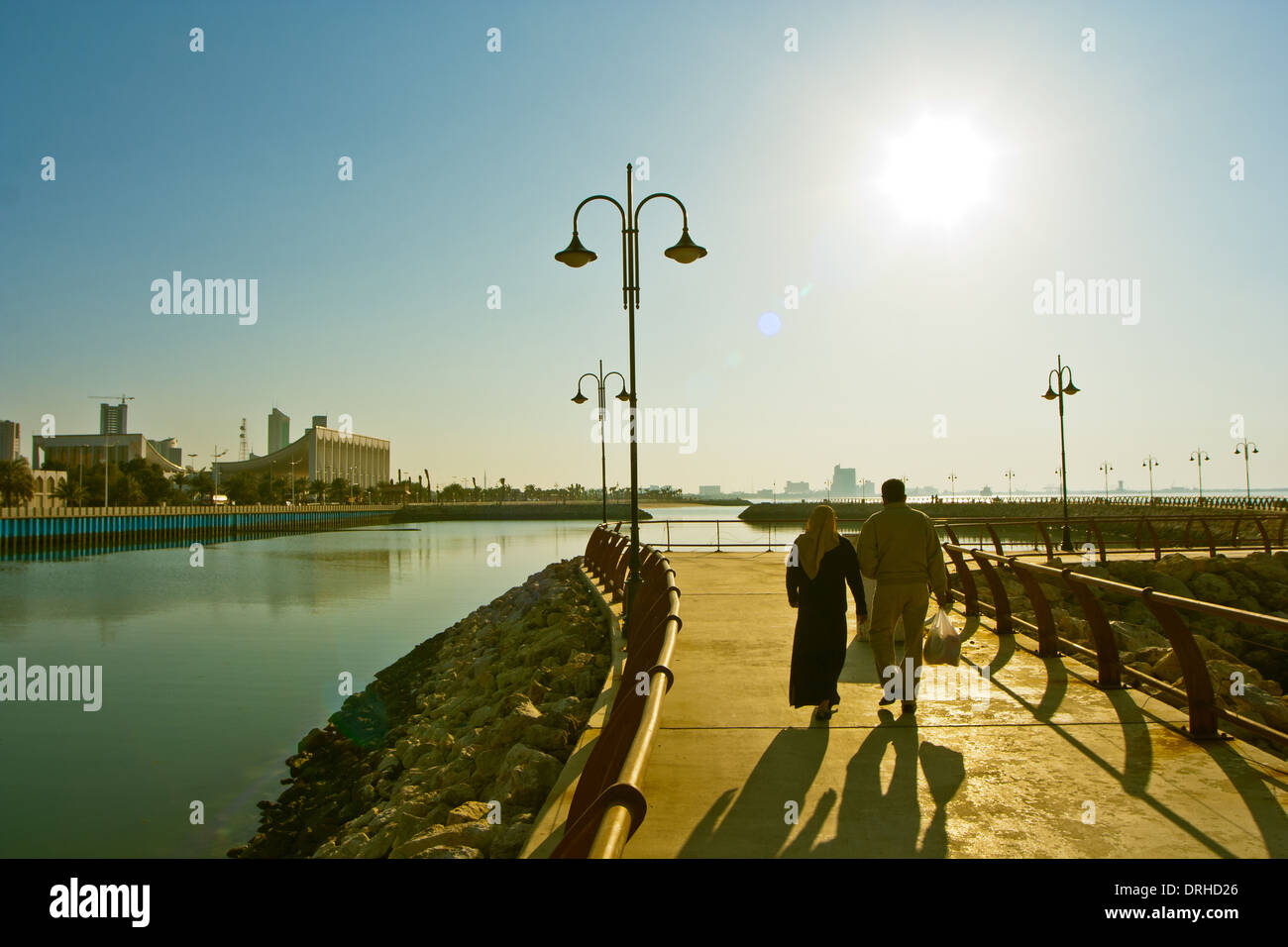 Couple walking by Kuwait waterfront Stock Photo - Alamy