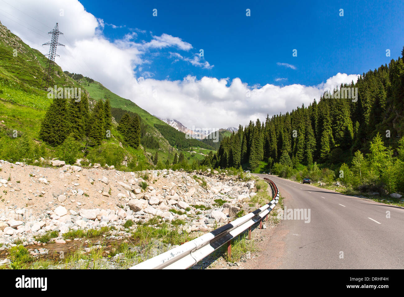 Road on Big Almaty Lake, nature green mountains and blue sky in Almaty ...