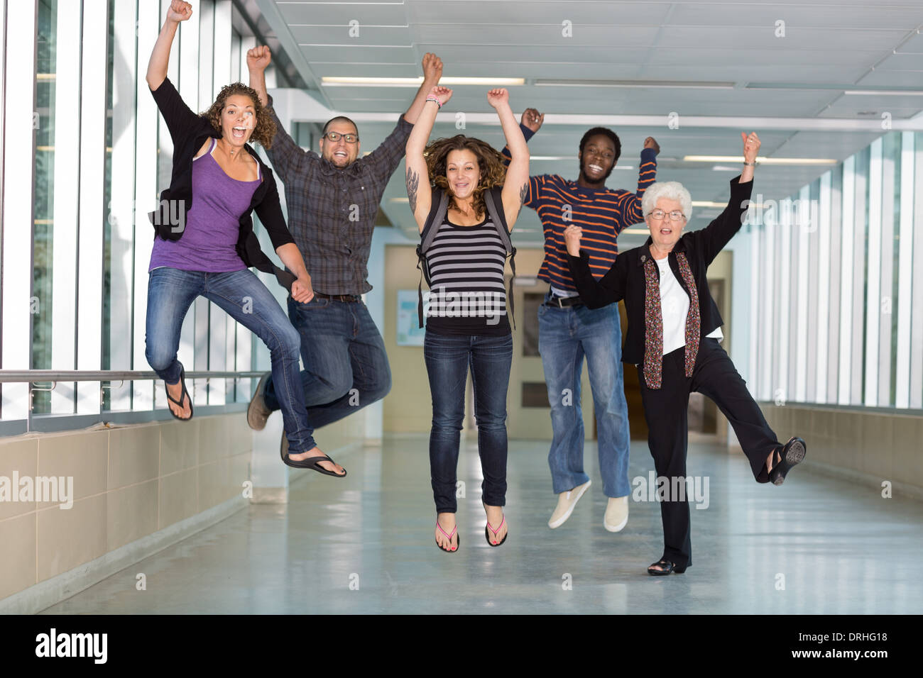 Excited Multiethnic University Students Jumping Stock Photo - Alamy