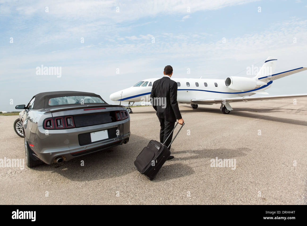 Businessman Standing By Car And Private Jet At Terminal Stock Photo - Alamy