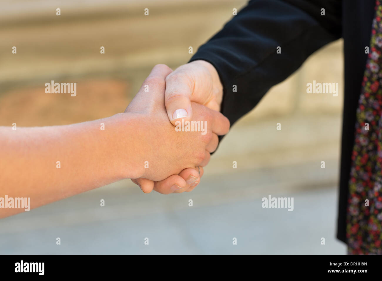 Cropped Image Of University Students Shaking Hands Stock Photo - Alamy