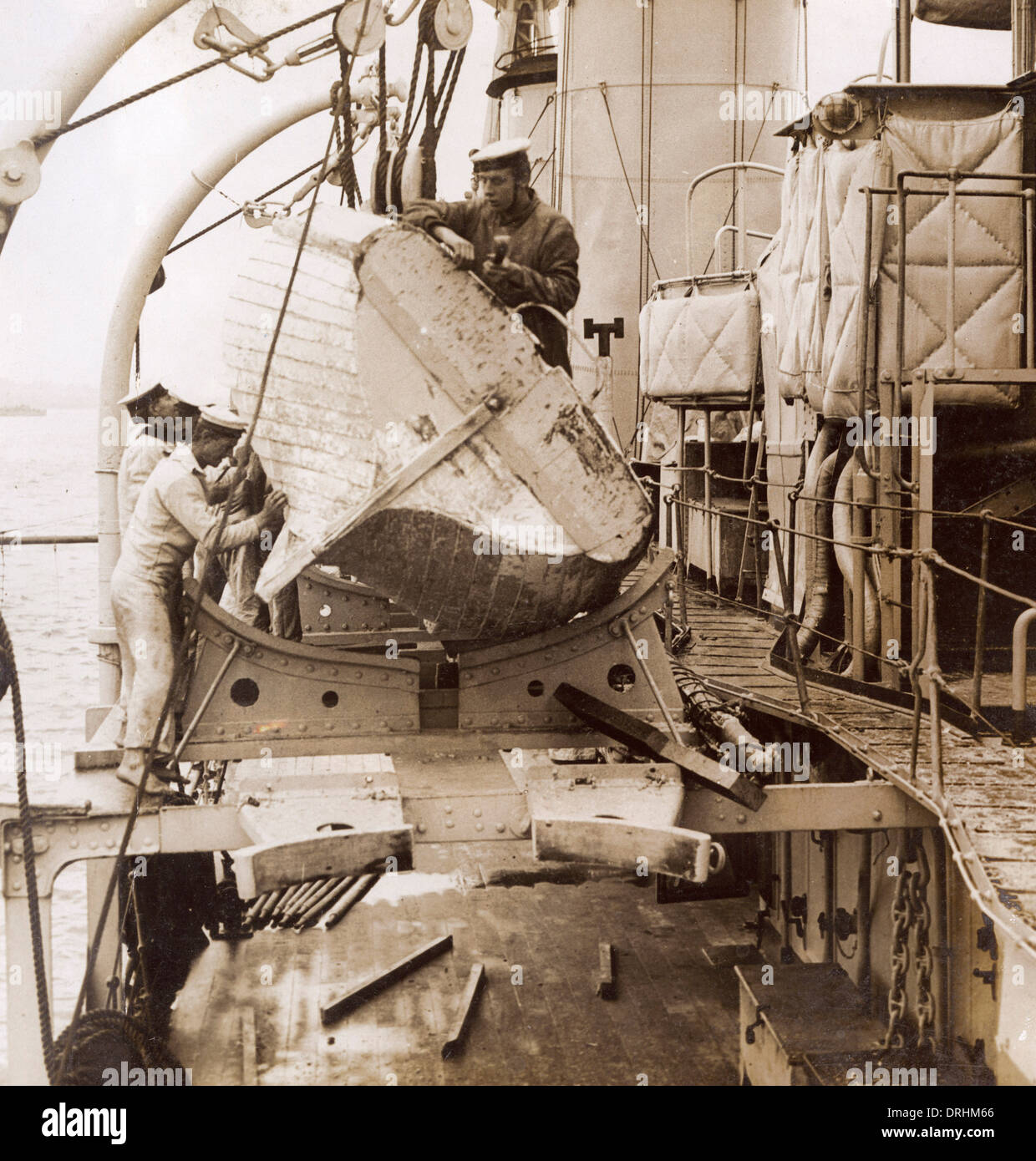 Sailors repairing a boat on a ship, WW1 Stock Photo - Alamy